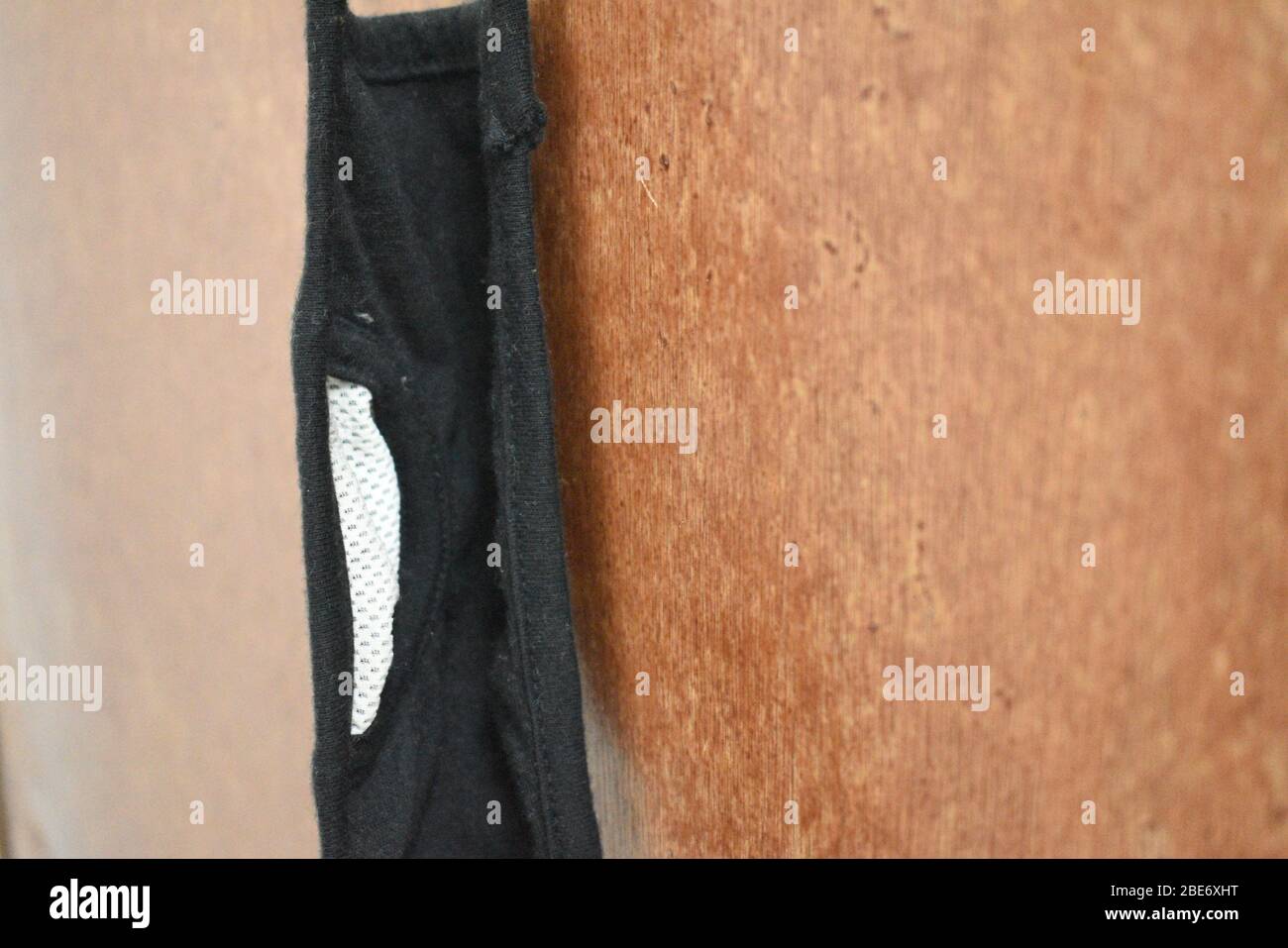 Black color face mask holding in the wall.Cover mouth and nose with ...