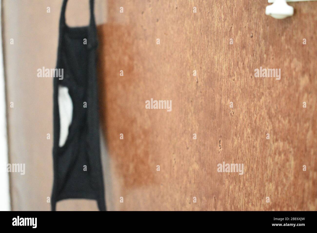 Black color face mask holding in the wall.Cover mouth and nose with ...