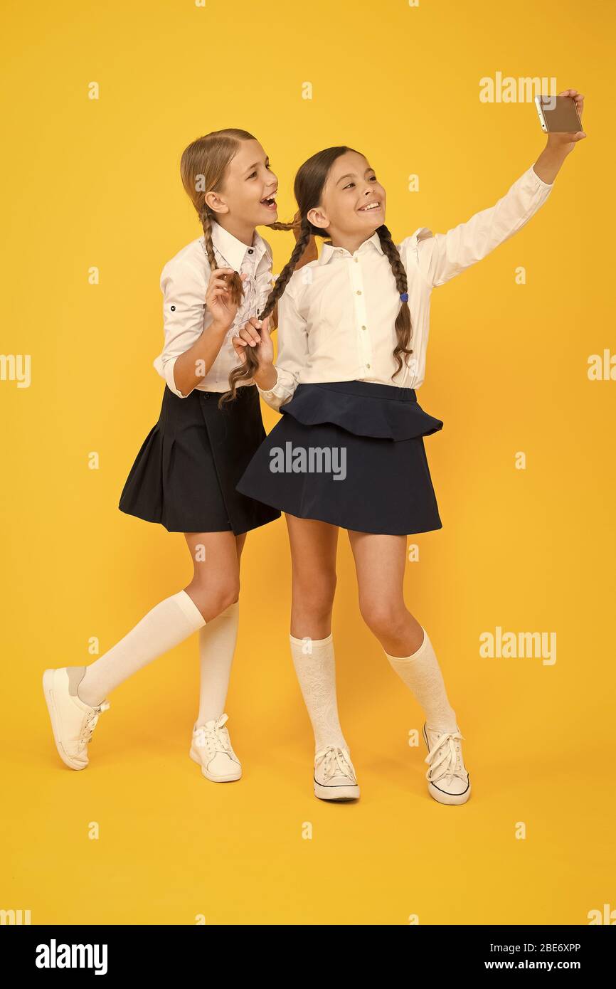 Little blogger. Blogger school. Schoolgirls bloggers use smartphone ...