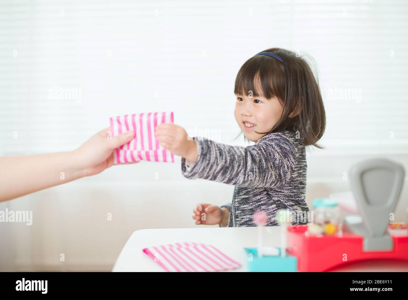 toddler girl pretend play sweet shop keeper at home Stock Photo - Alamy