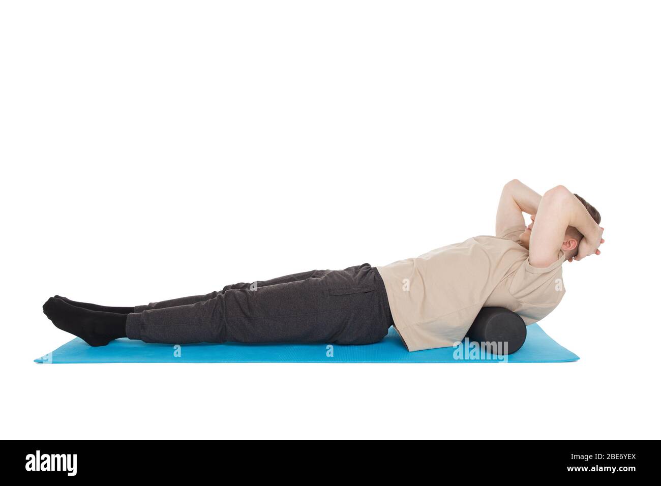 Handsome man shows exercises using a foam roller for a myofascial ...