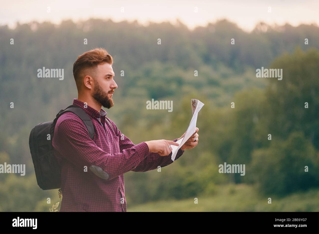 Man tourist in mountain read the map Stock Photo - Alamy