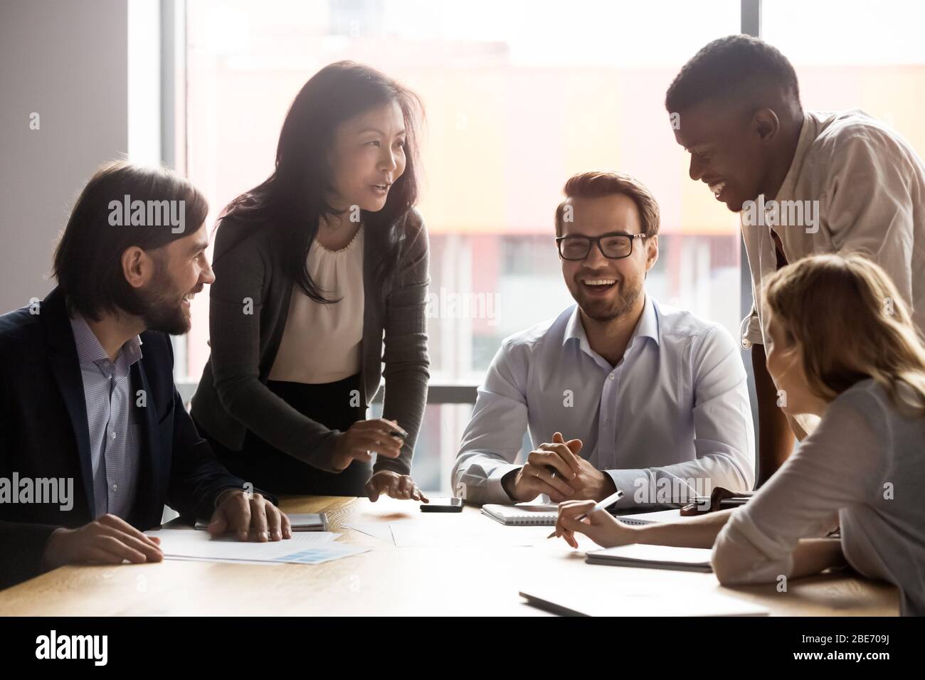 Happy diverse colleagues have fun brainstorming at meeting Stock Photo ...