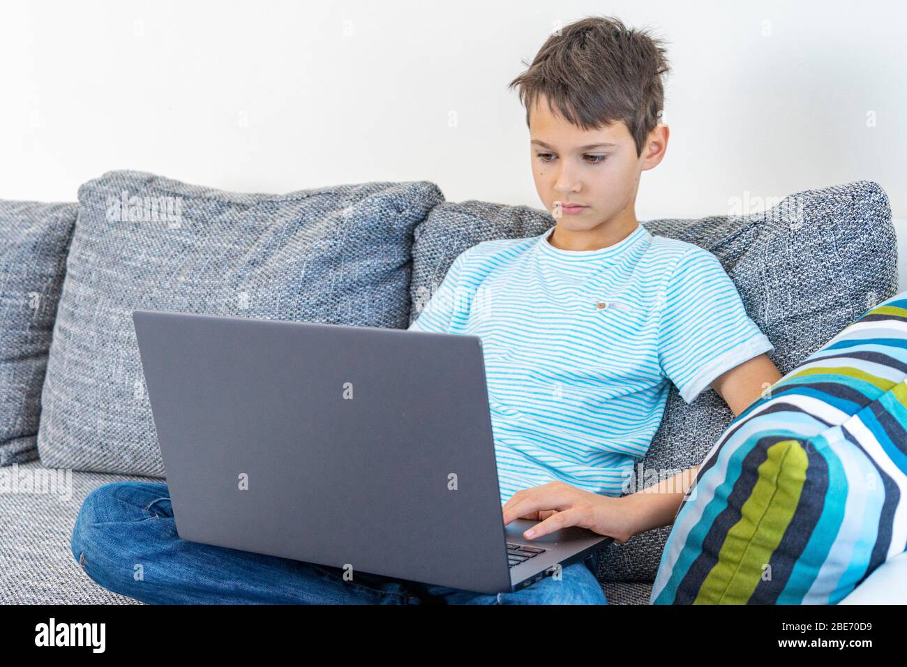 Child using laptop computer at home. Technology, online learning ...