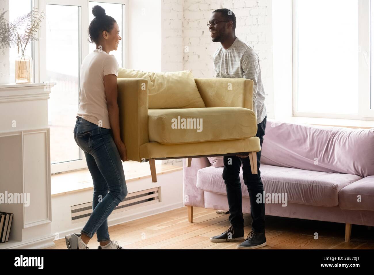 Young happy african american couple moving and carry table Stock Photo ...