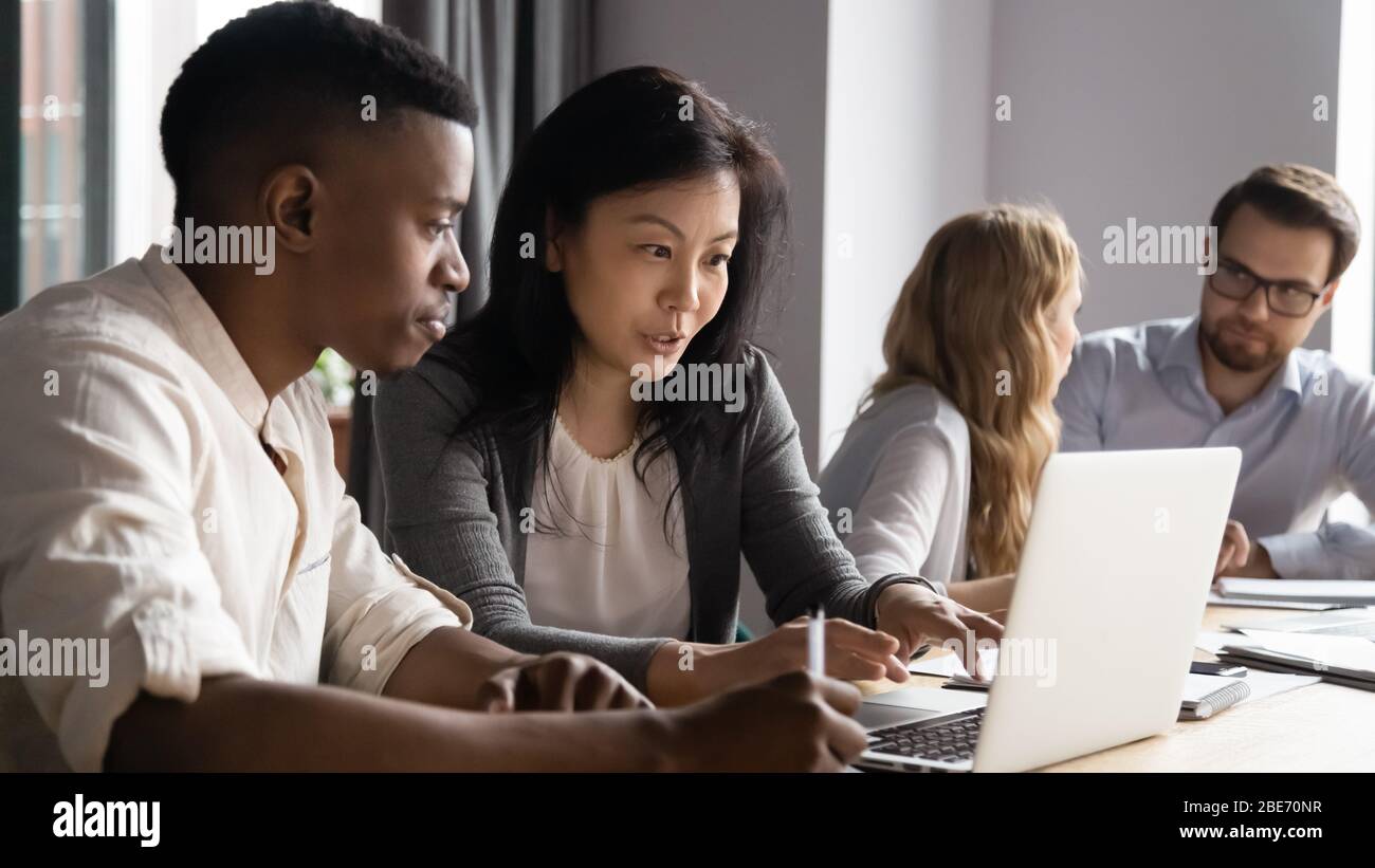 Diverse team coworkers analyzing business hi-res stock photography and ...