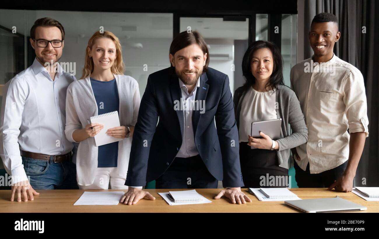 Portrait of motivated successful office team posing together Stock ...