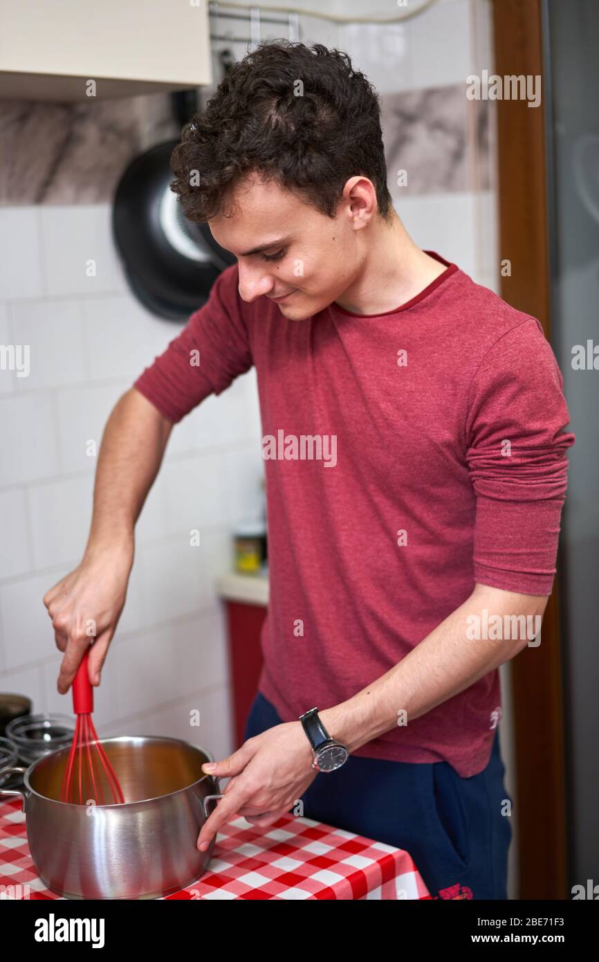 Boy stirring dough in bowl hi-res stock photography and images - Alamy