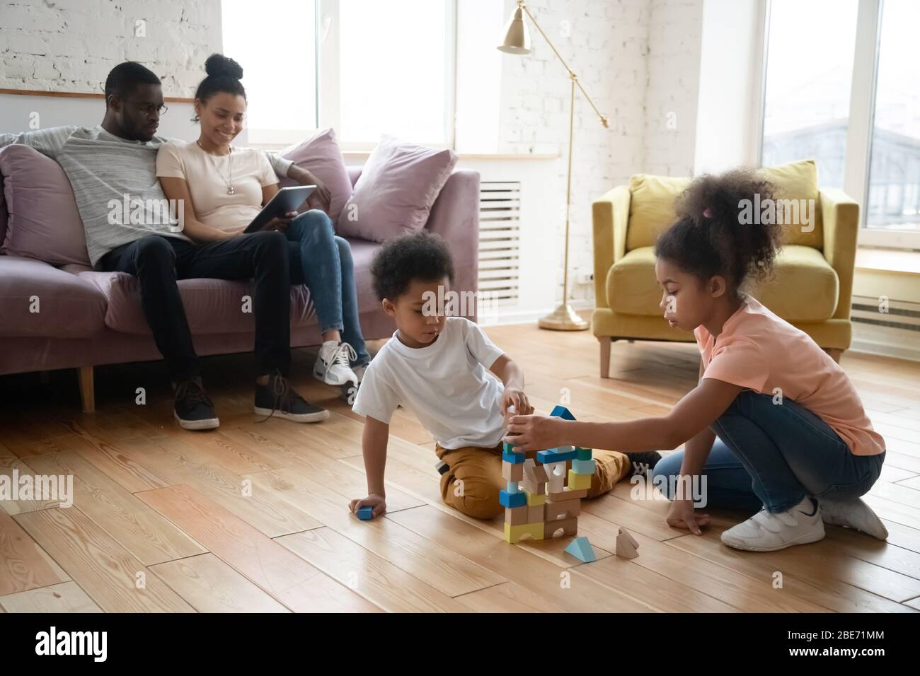 Happy african american brother and sister building constructor tower ...
