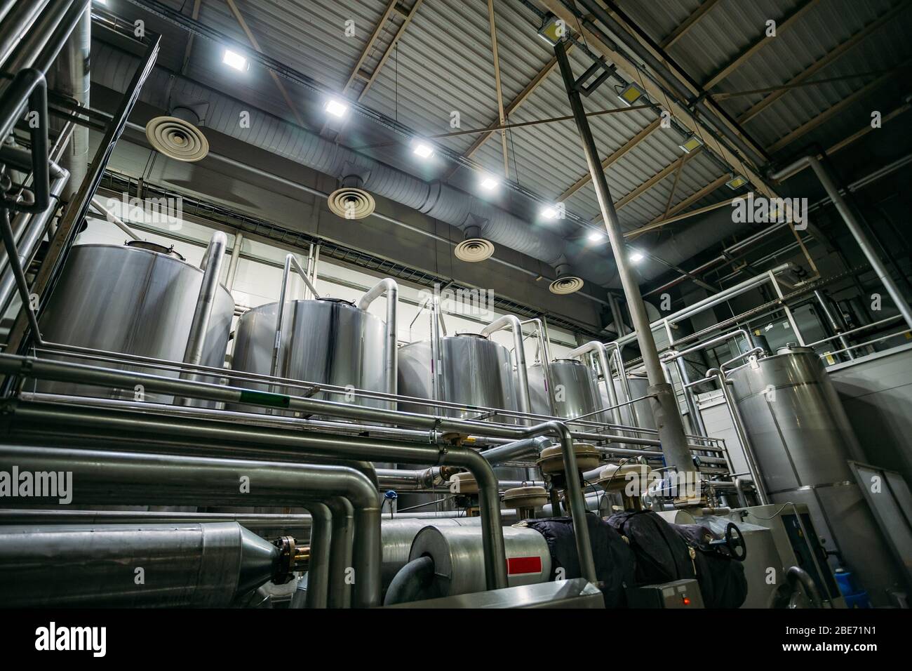 Industrial stainless steel fermentation vats in modern brewery Stock ...