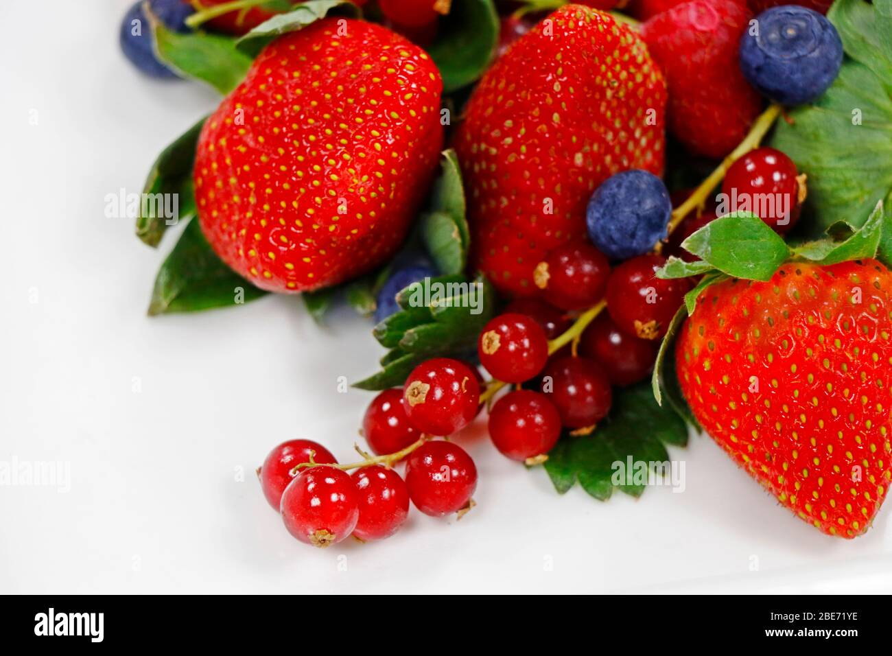 assorted fresh berries on a white background Stock Photo - Alamy