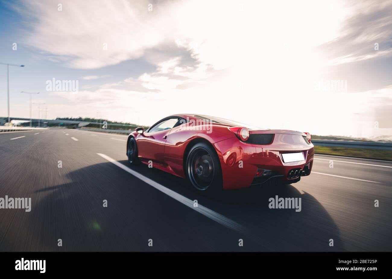 Red luxury model sport car view from behind on the highway Stock Photo ...