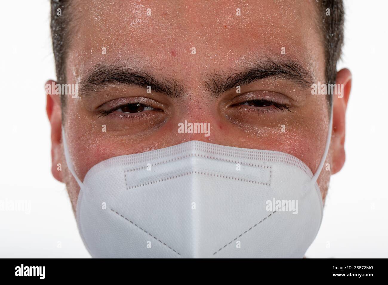 Corana patient with high fever wearing a face mask Stock Photo - Alamy