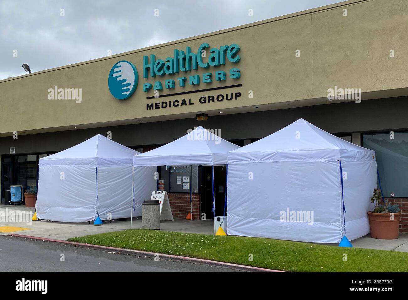 White tents in front of HealthCare Partners medical group amid the ...