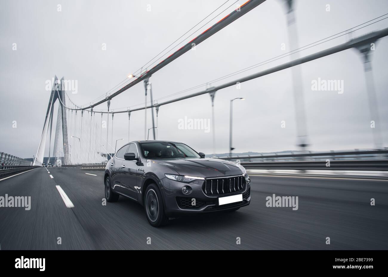 Grey offroader sport car driving over the bridge in the dusk Stock ...