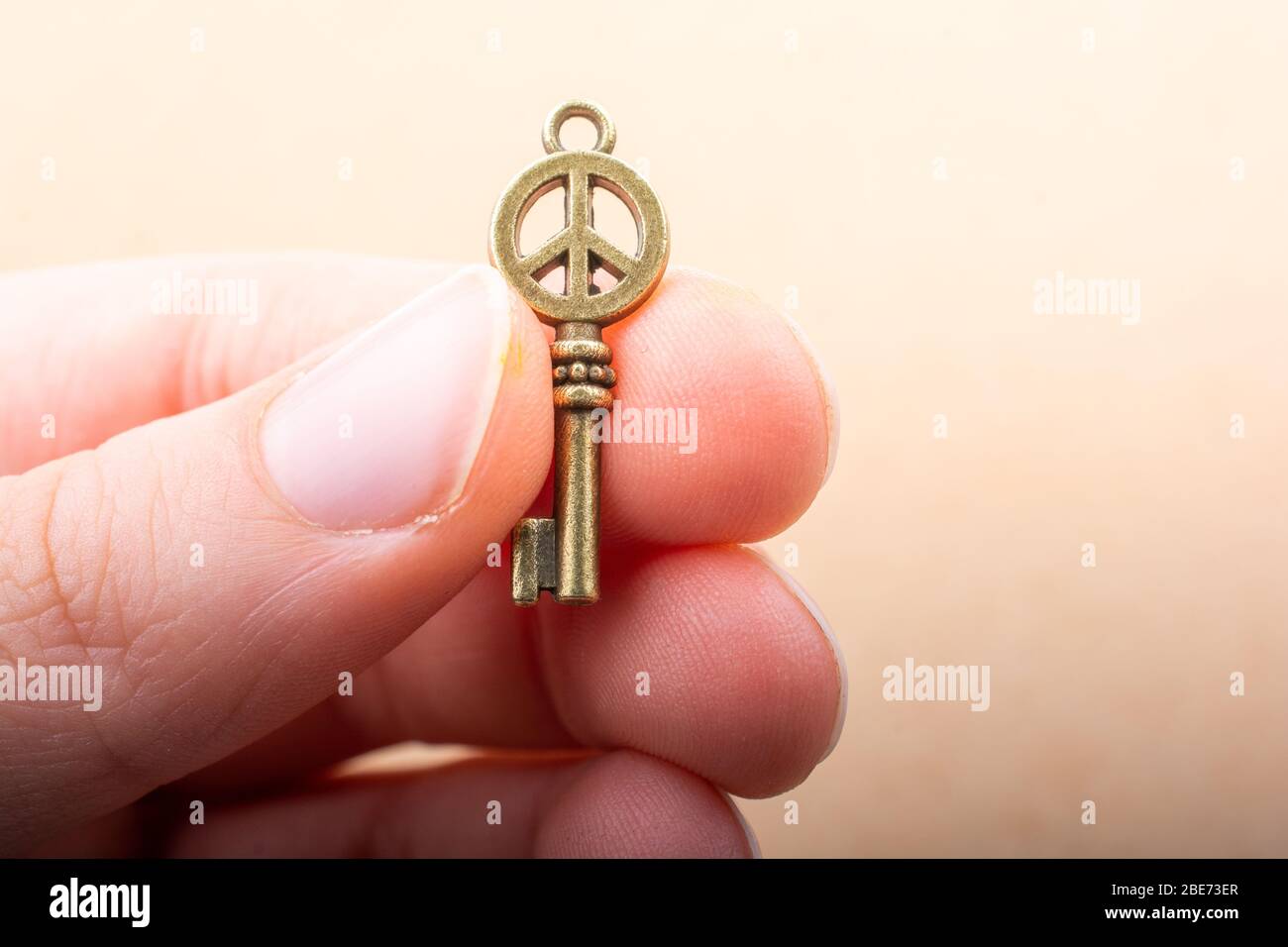 Peace symbol key in hand over and retro style metal keys Stock Photo ...