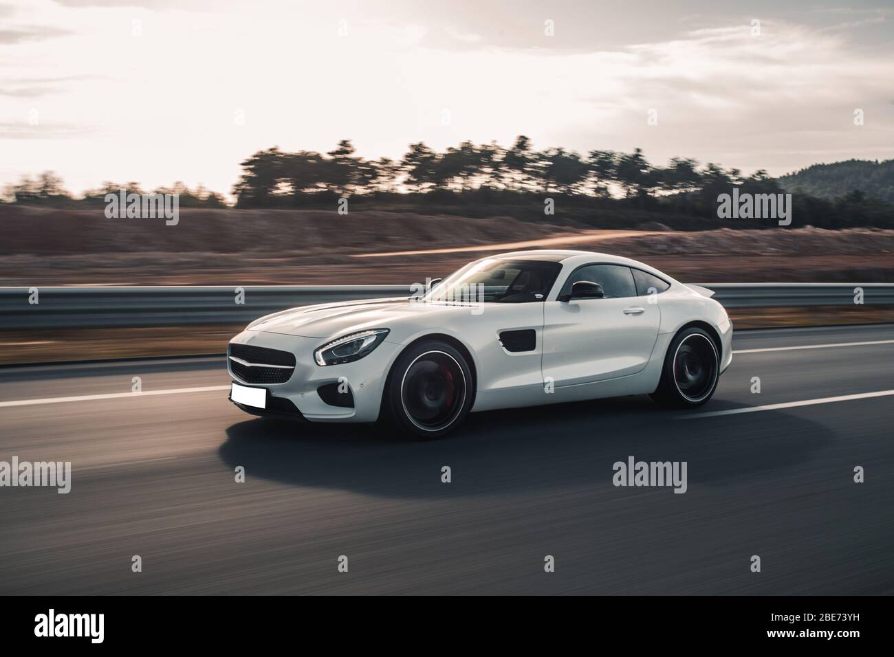 White luxury model sport car profile view on the highway, profile view ...