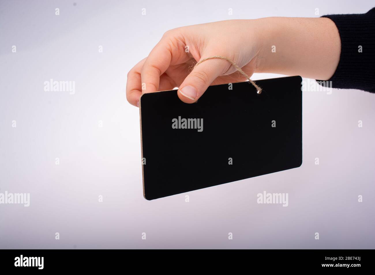 Rectangular shaped black notice board in hand on white background Stock ...