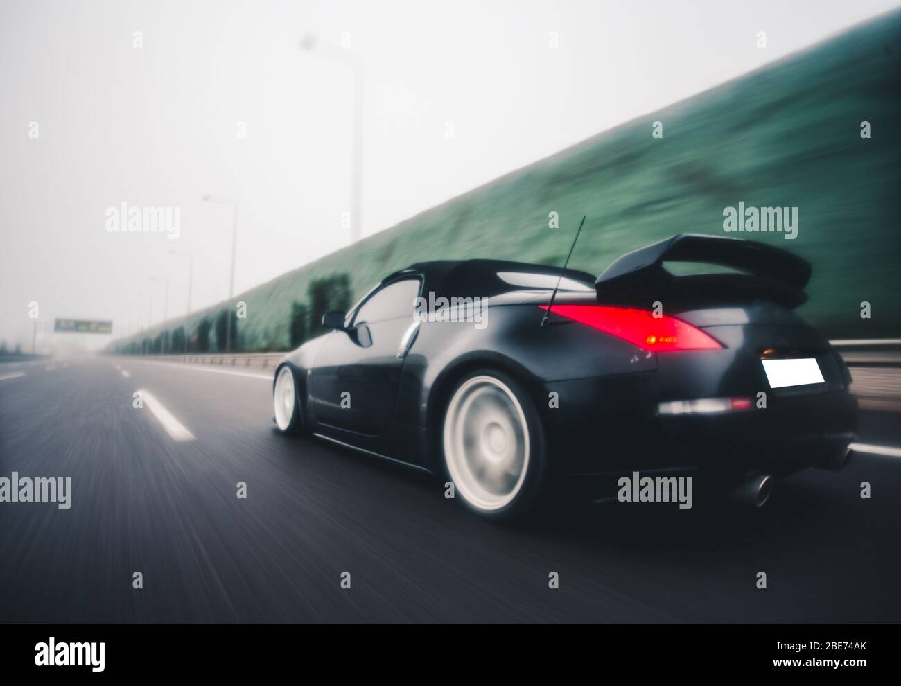 Black sport car high speed drive on the highway, back view Stock Photo ...