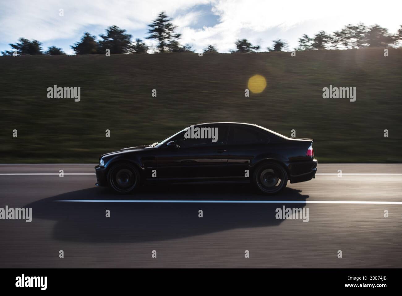 Black luxury sport car high speed driving in the dark of the evening ...