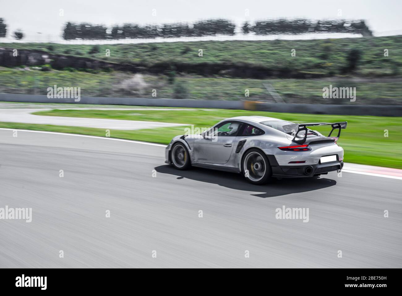 Silver color sport car racing on the trace Stock Photo - Alamy