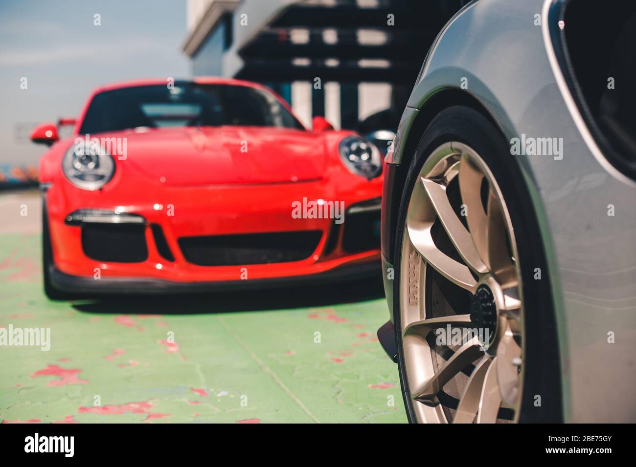 Silver and red sport cars in a row at the stadium Stock Photo - Alamy