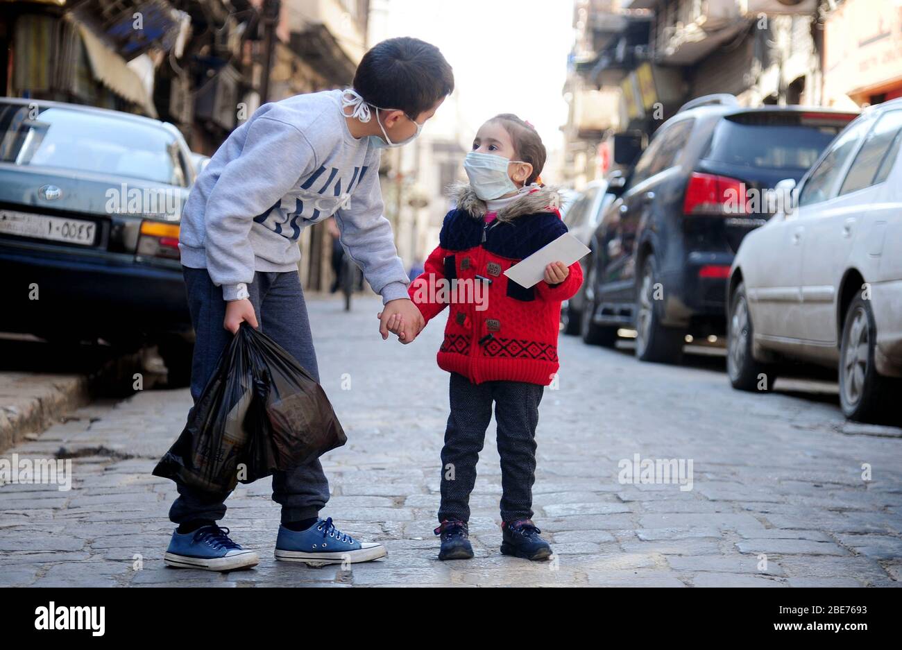 Damascus, Syria. 12th Apr, 2020. Kids wearing masks are seen in ...