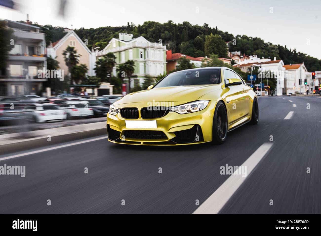 Driving yellow sport car in the city road Stock Photo - Alamy