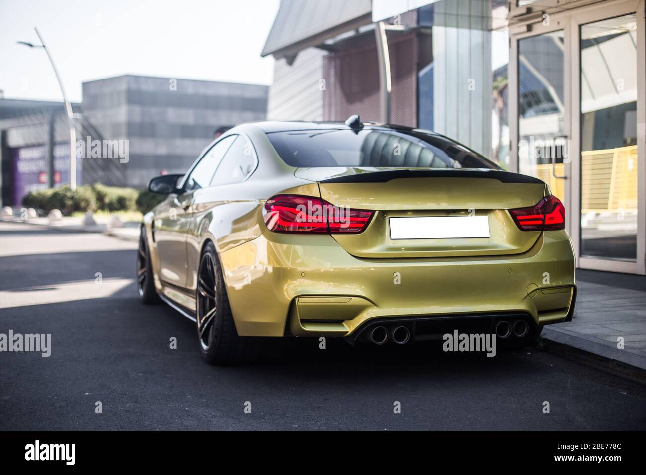Yellow brand sport car on the city roads Stock Photo - Alamy
