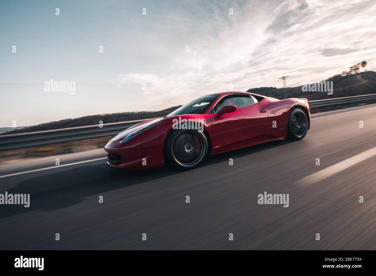 Red luxury sport car with red lights driving in the dusk time Stock ...