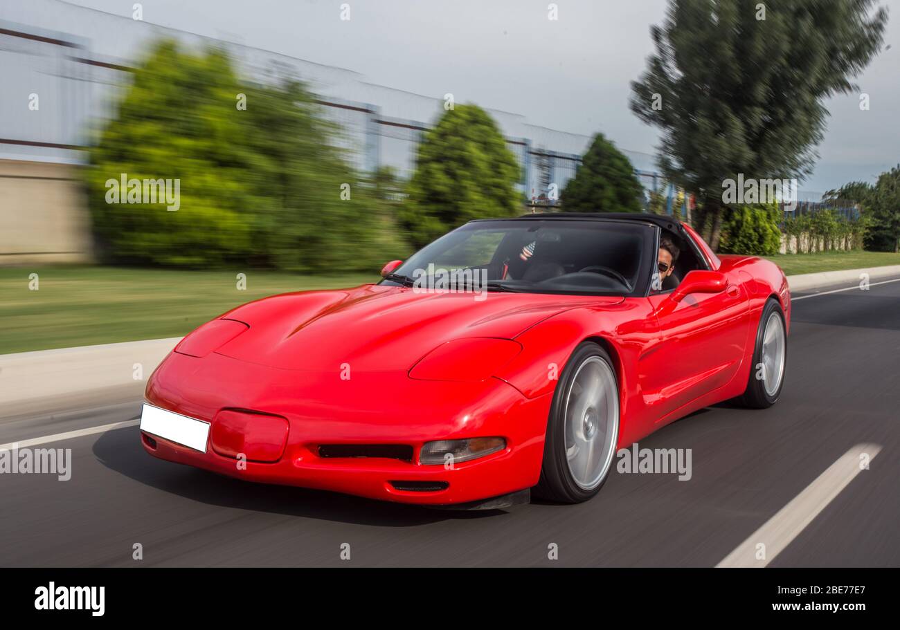 Red sport coupe driving on the highway Stock Photo - Alamy