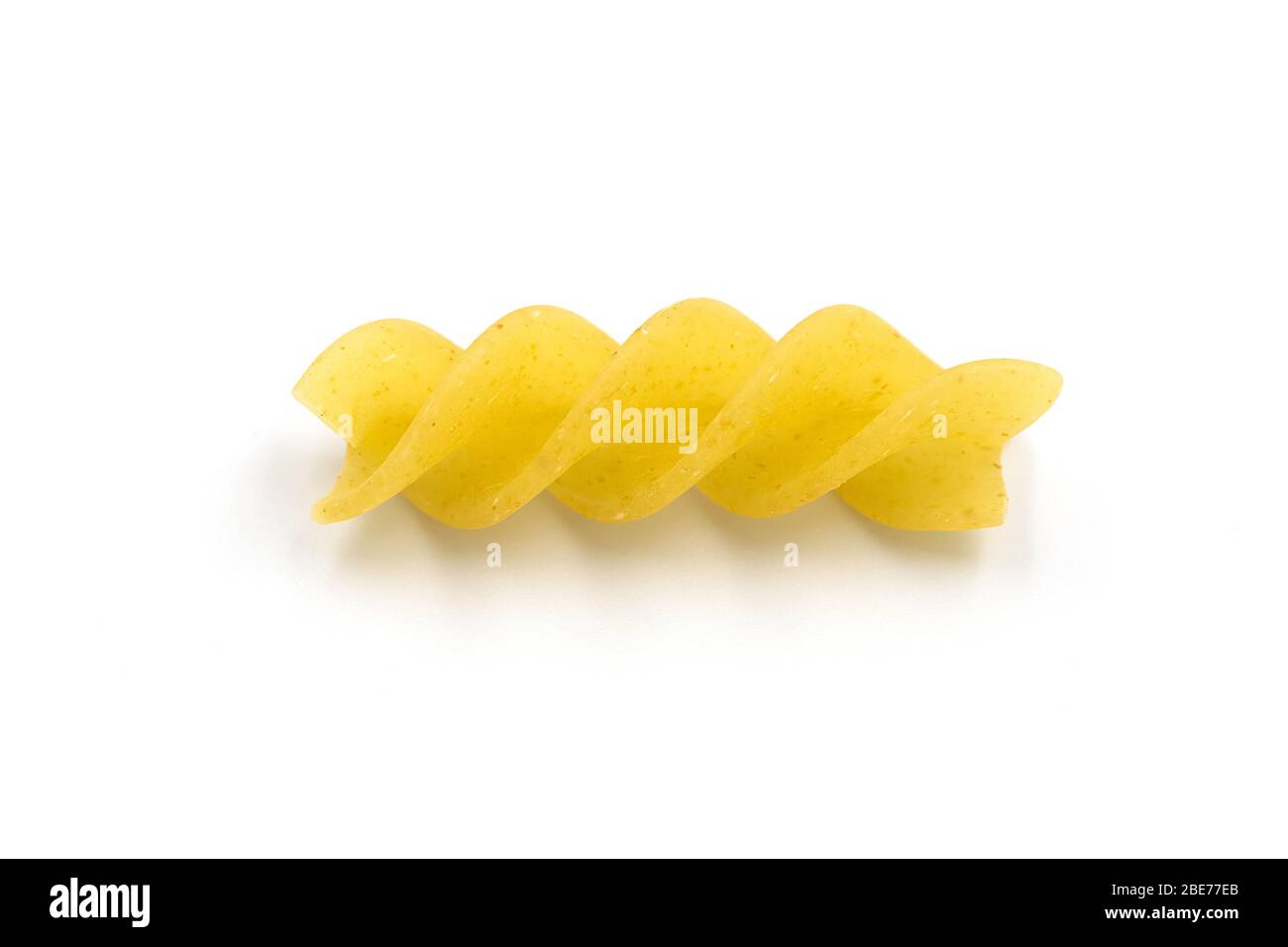 Homemade fusilli pasta on white isolated background in macro top view ...