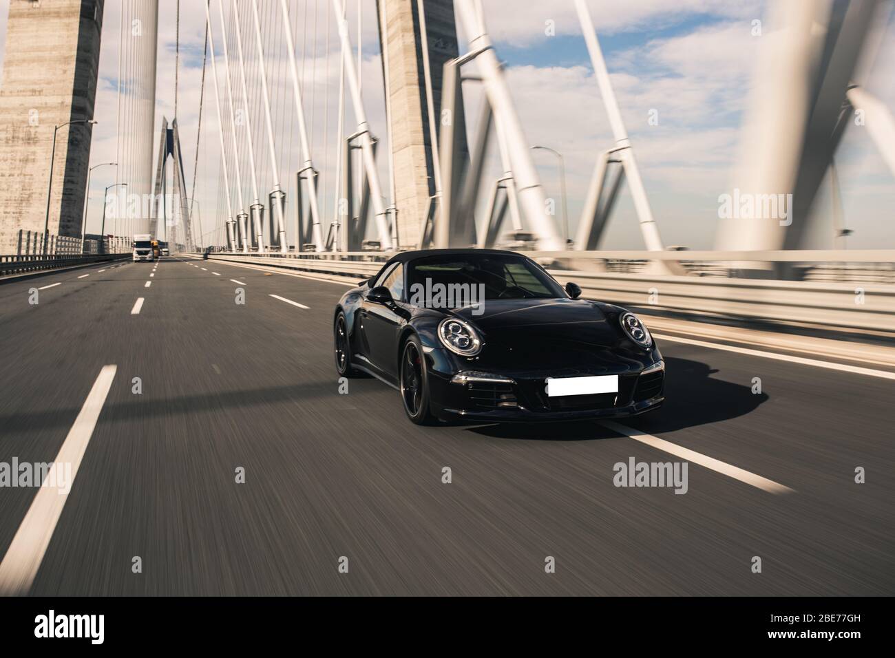 Black sport cabriolet driving over the bridge Stock Photo - Alamy