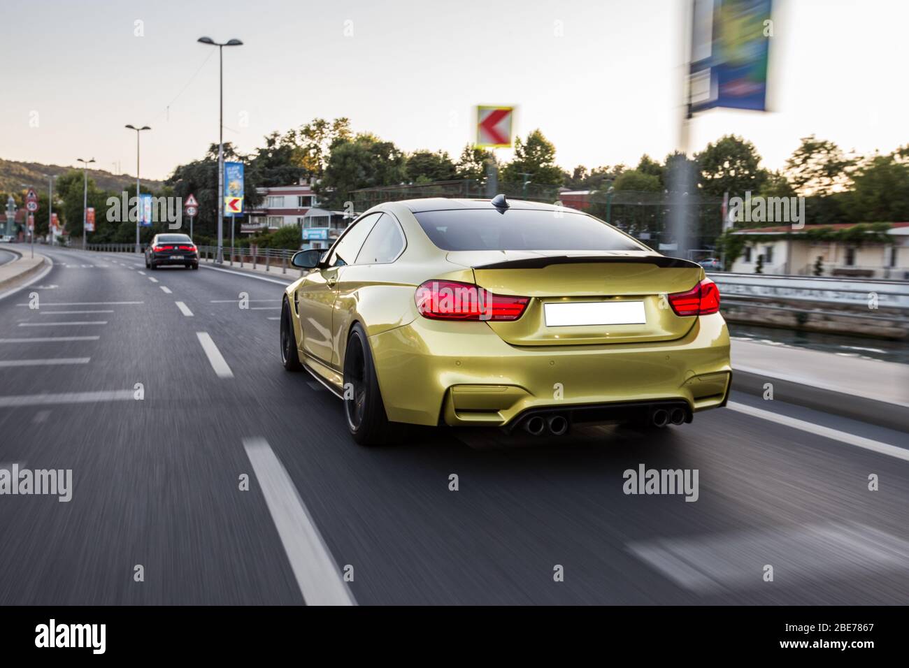 Yellow sedan car on the city roads Stock Photo - Alamy