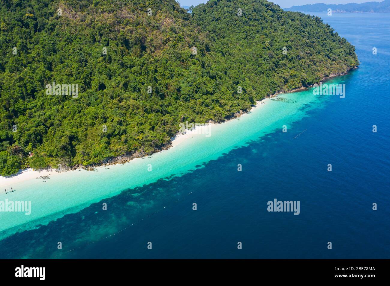 Aerial view ocean waves, beach and rocky coastline and beautiful forest ...
