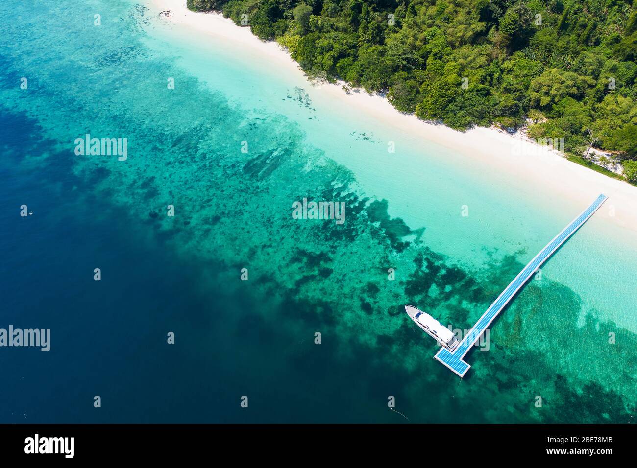 Aerial view ocean waves, beach and rocky coastline and beautiful forest ...