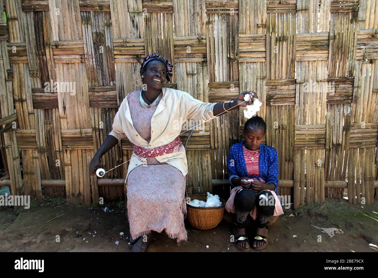 Smiling Dorze Tribe Woman seated in Front of a Bamboo Fence ...
