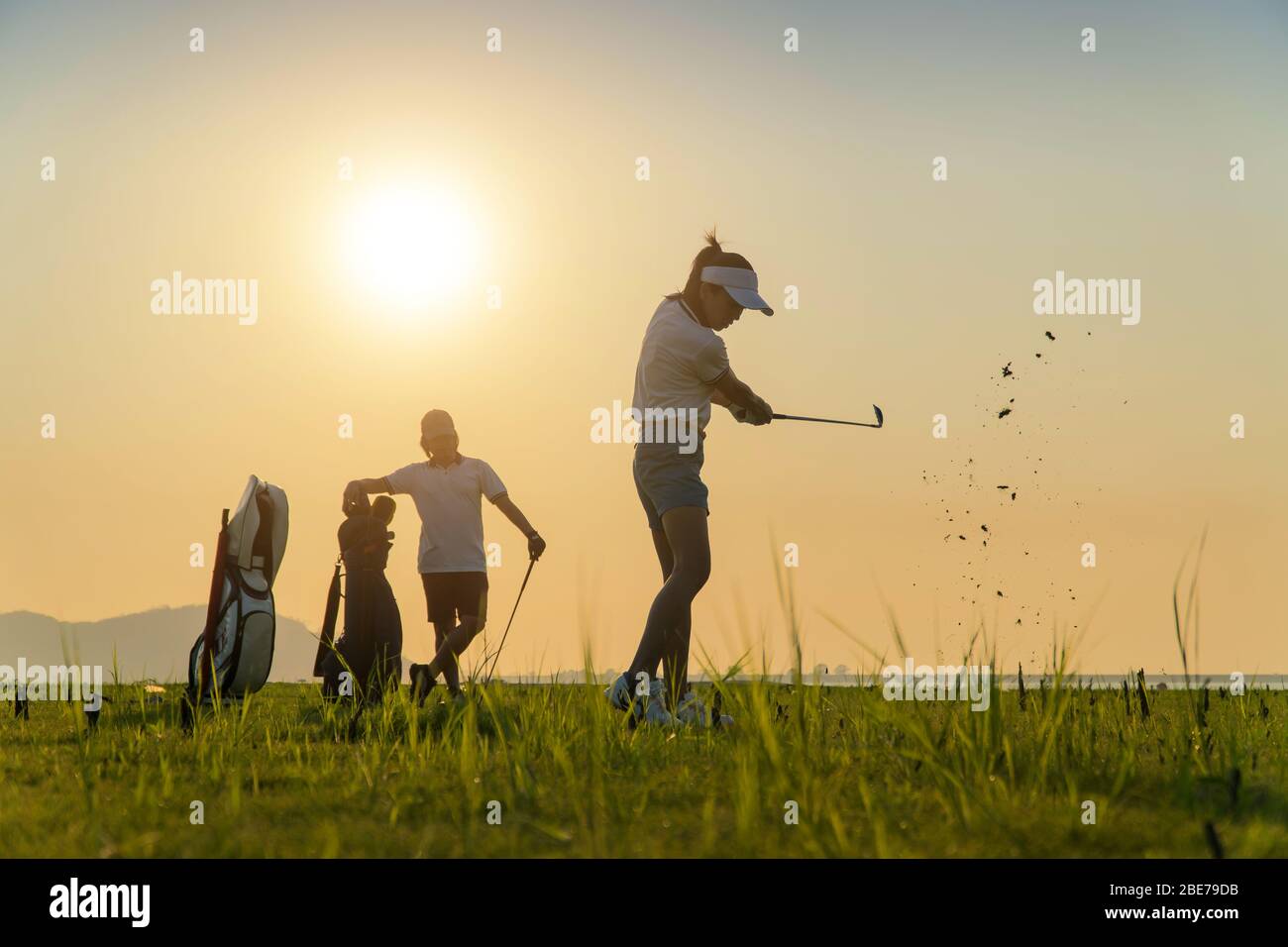 Couple lover in action of playing golf together. Golf ball away from ...