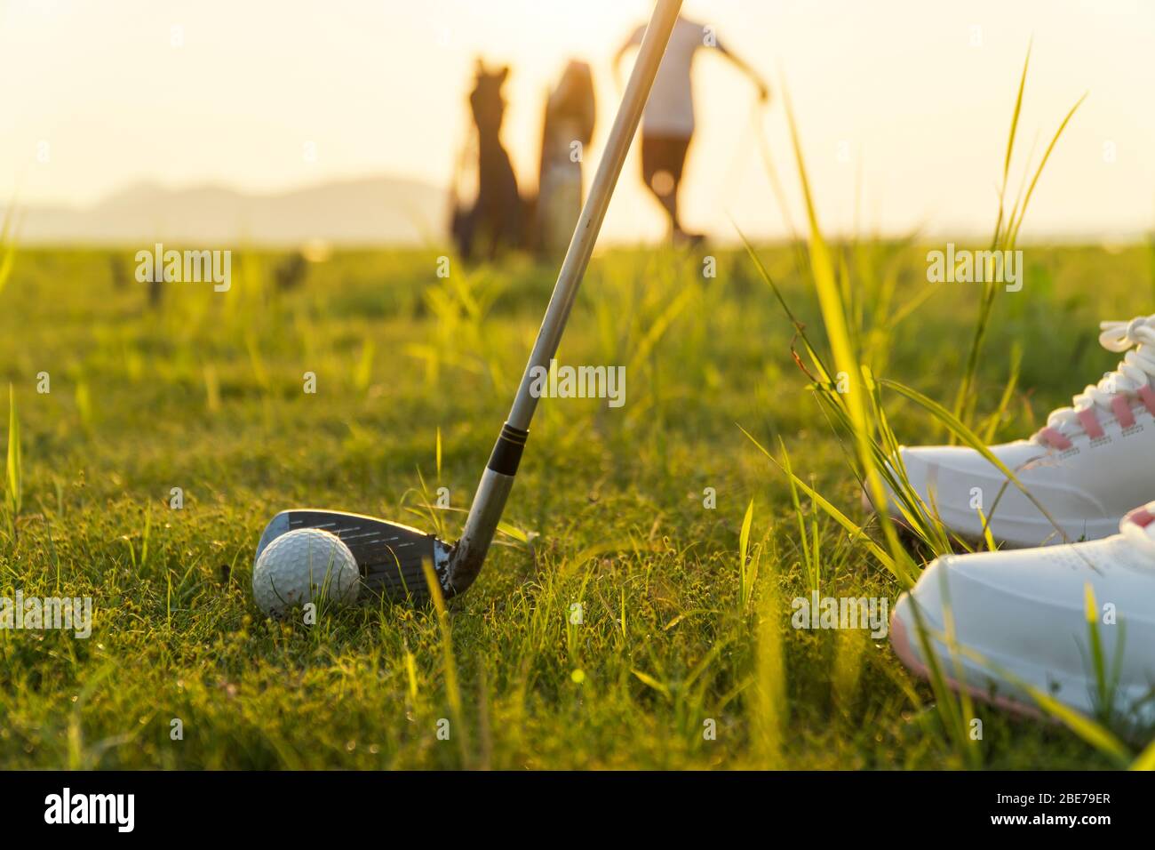 Couple lover in action of playing golf together. Golf ball away from ...
