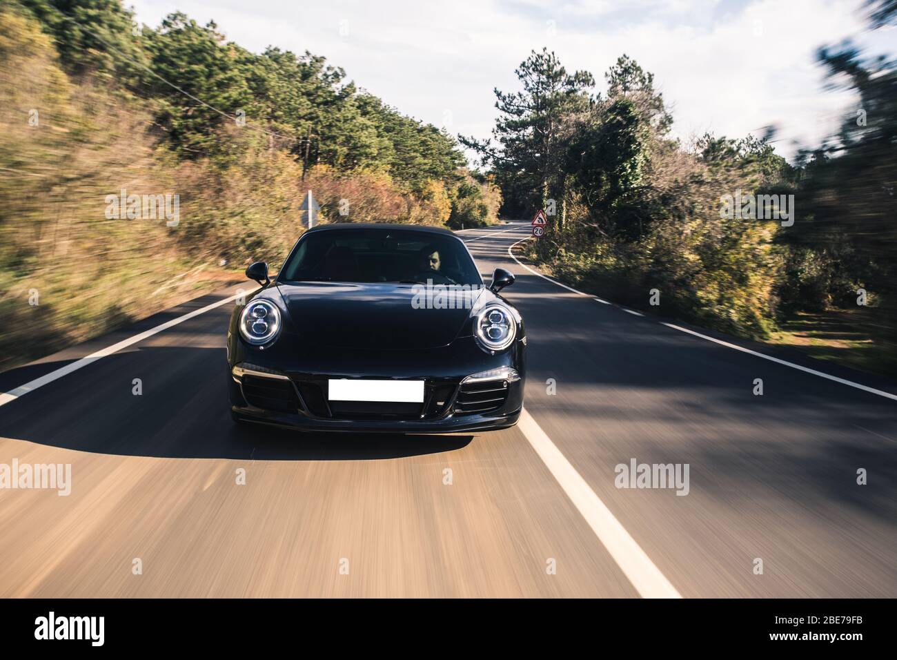 Black super model sedan car on the forest road, front view Stock Photo ...