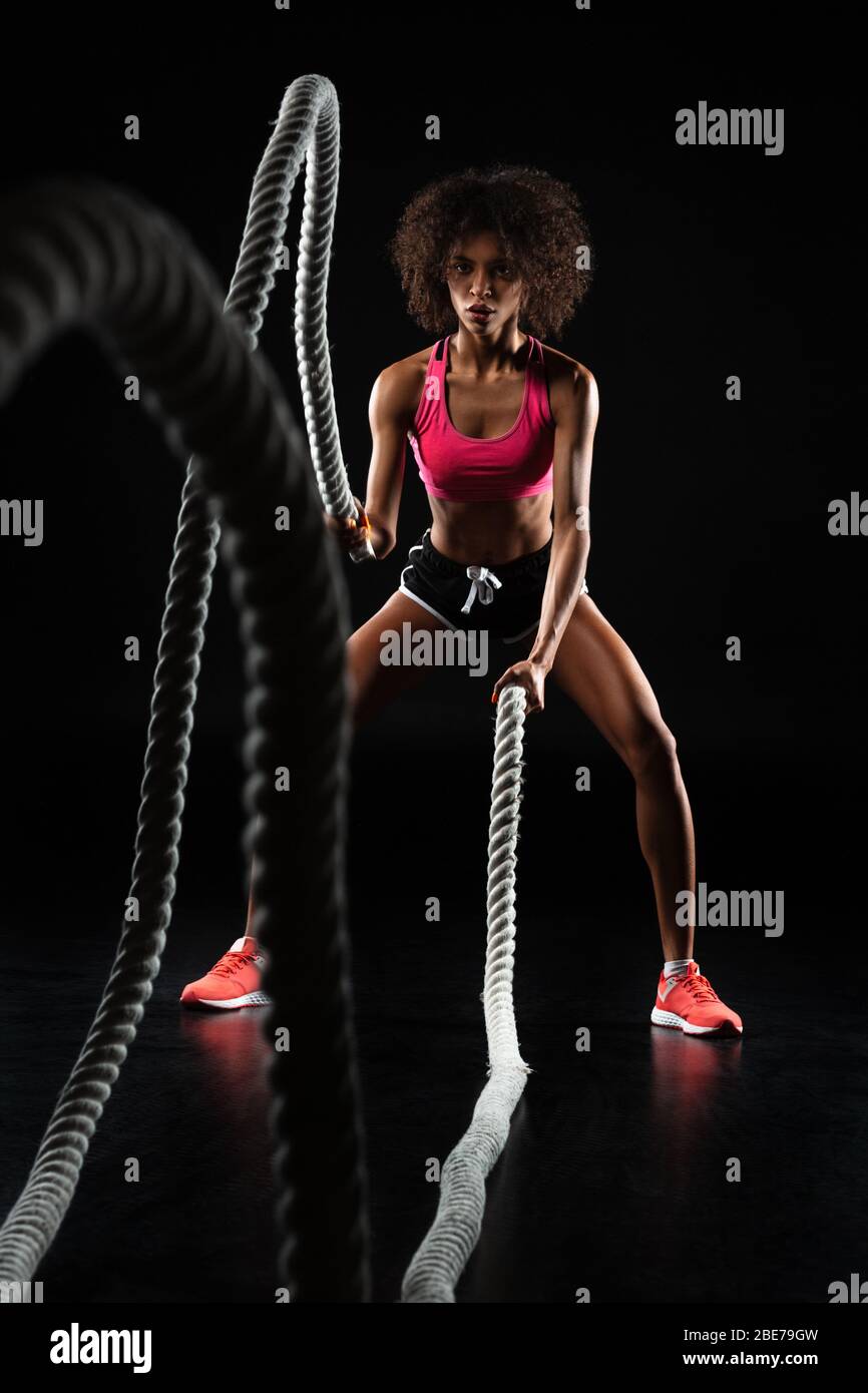 Image of athletic african american sportswoman doing exercise with ...
