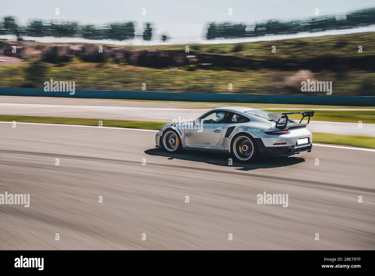 Silver color sport car racing on the highway Stock Photo - Alamy