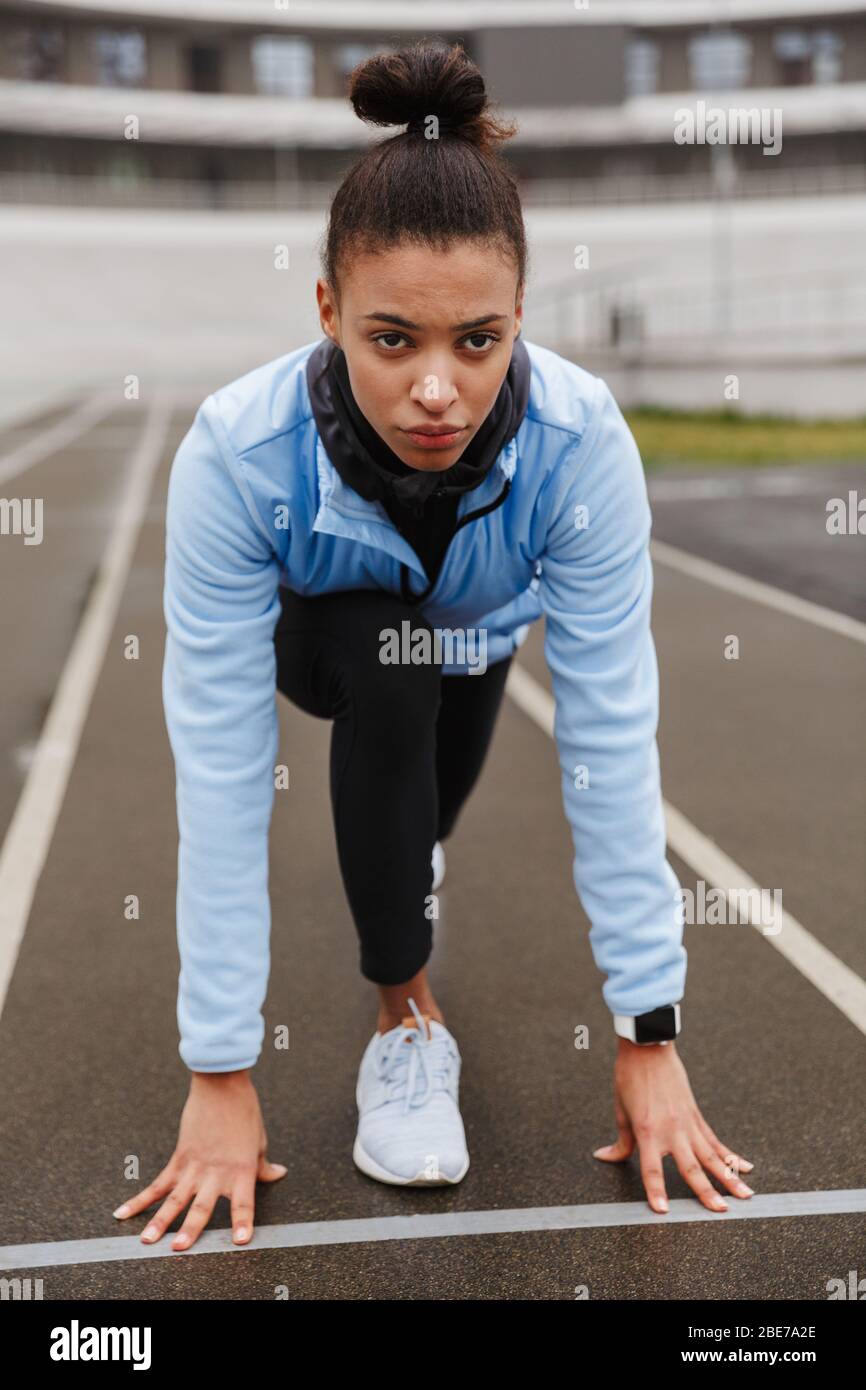 Beautiful young fit confident african sportswoman running at the ...
