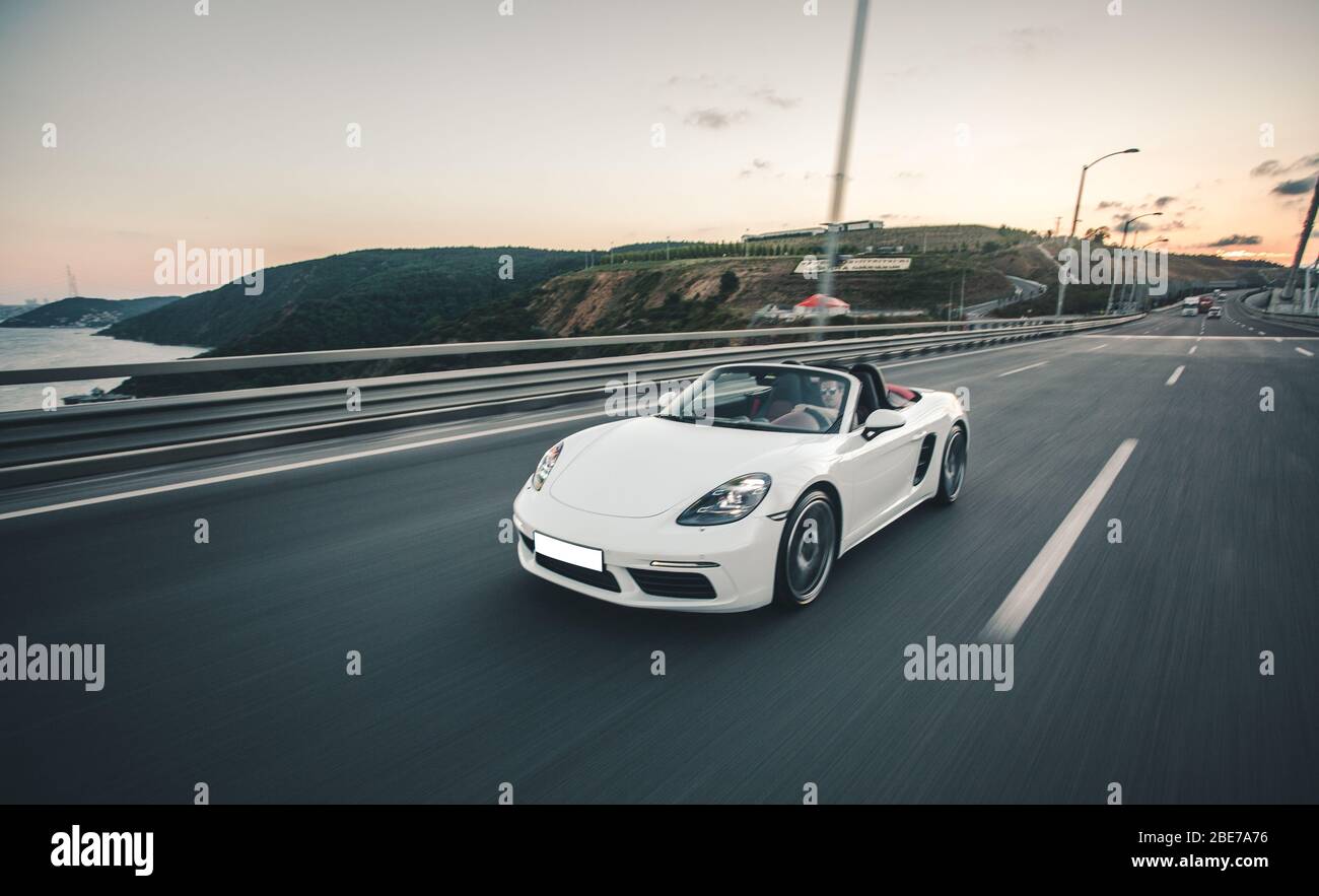White super model car driving at the seaside Stock Photo - Alamy