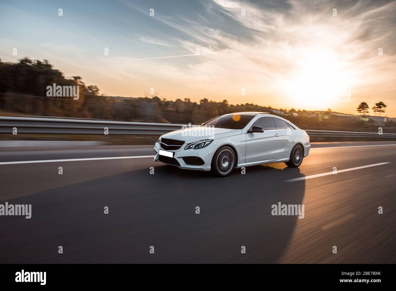 White business class sedan car driving on the highway Stock Photo - Alamy