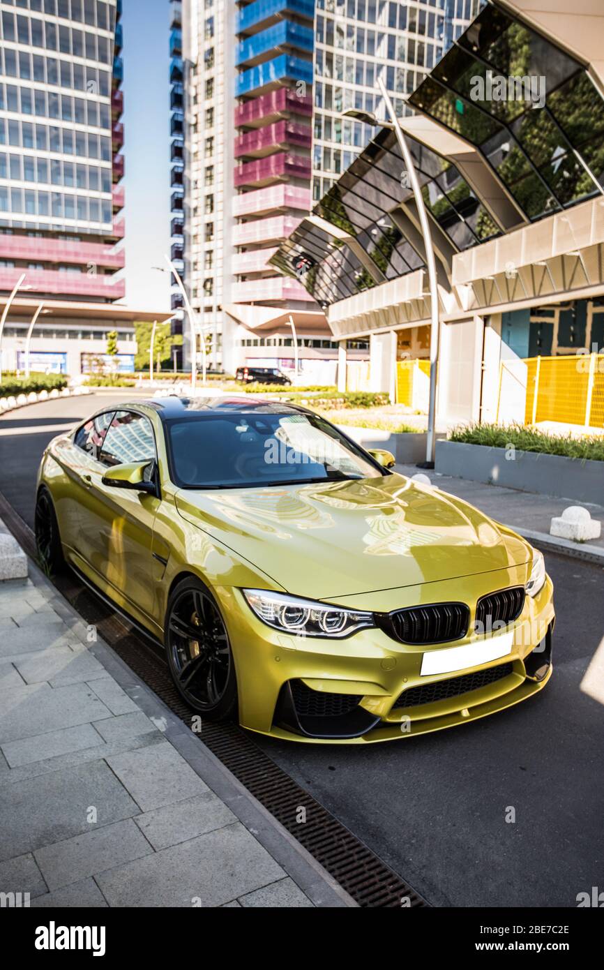 Yellow sport car parked at the side of the central road, upside view ...