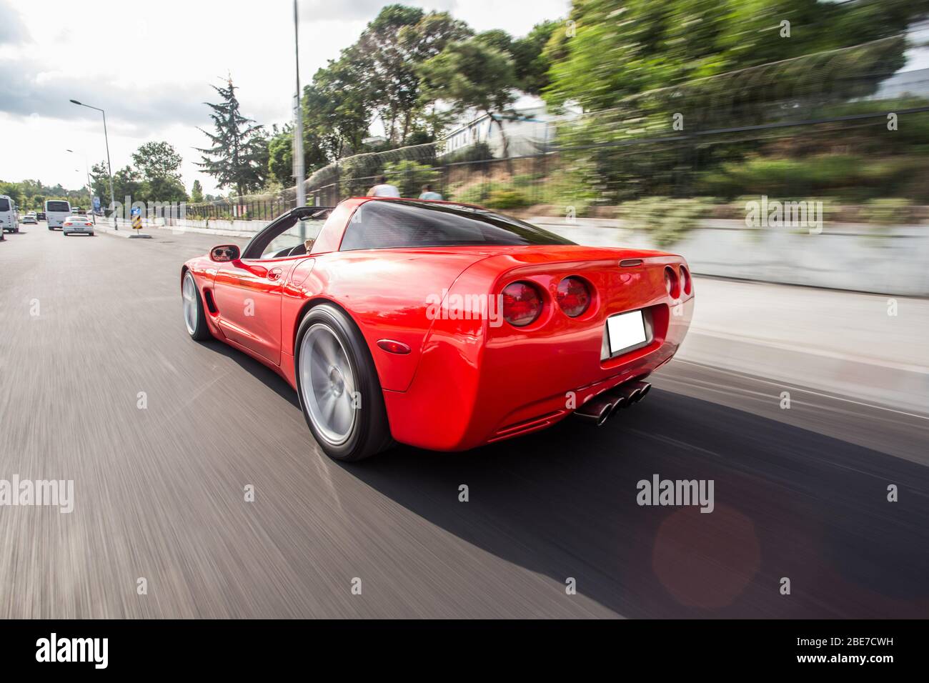 Red sport car high speed drive on the highway, back view Stock Photo ...