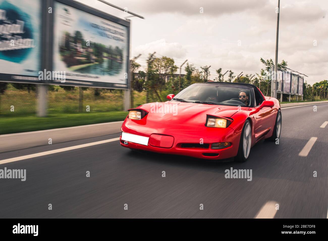 Red luxury sport car on the autobahn with commercials around Stock ...
