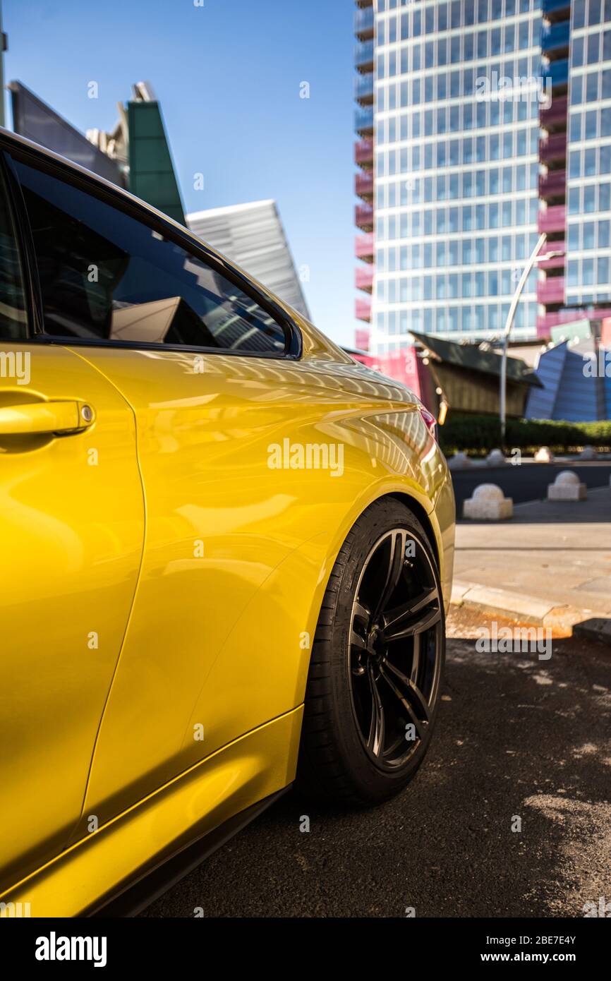 Back black wheel and door of a yellow car Stock Photo - Alamy