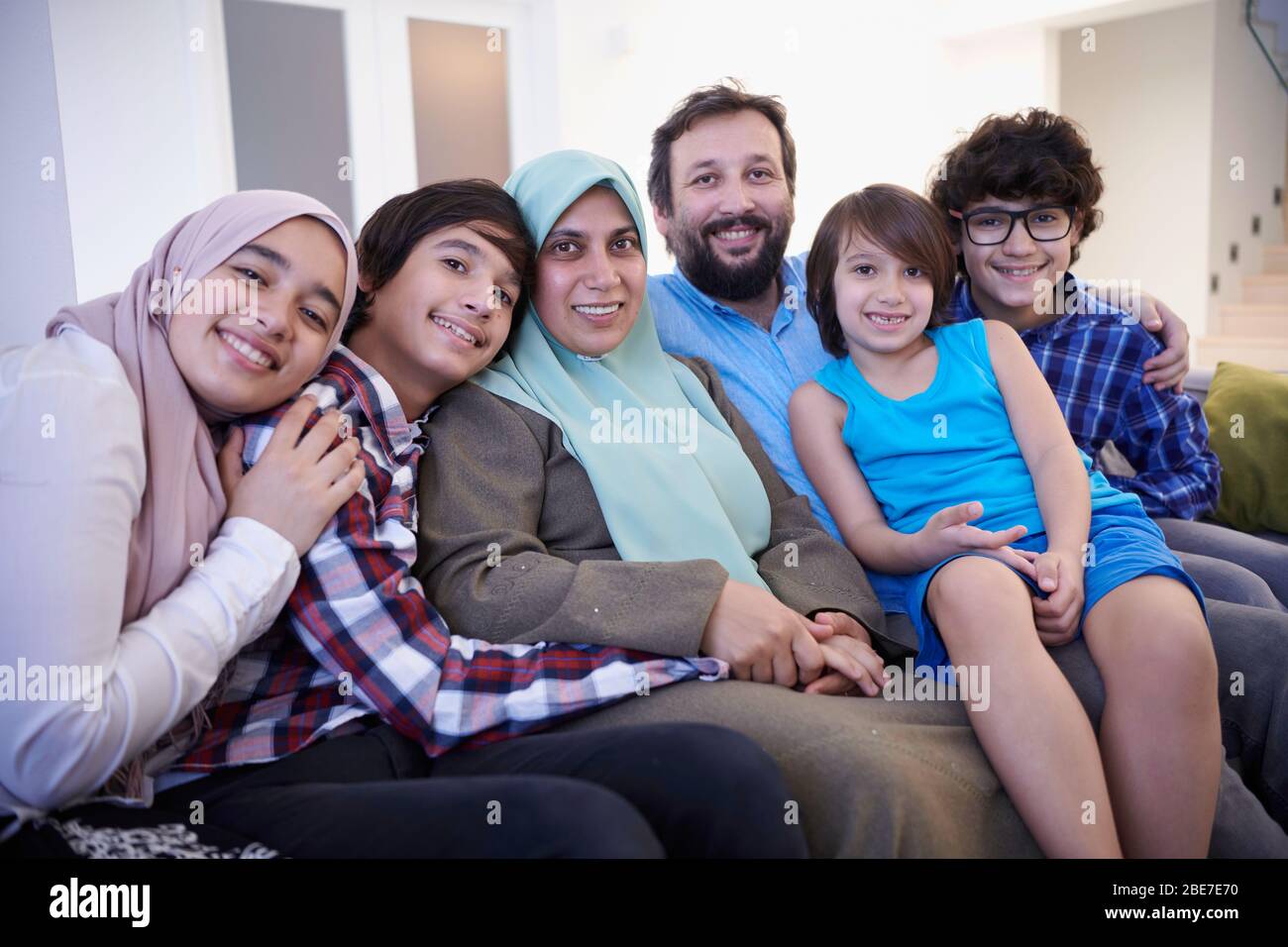muslim family portrait with arab teenage kids at modern home interior ...